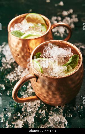 Moscow mule cocktail in copper cup with lime, ginger beer, vodka and ...