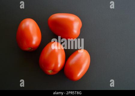 Roma tomatoes on a simple background Stock Photo - Alamy