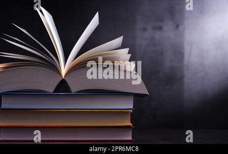 Composition with open book on the table Stock Photo - Alamy