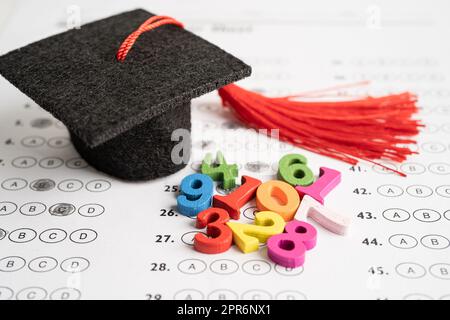 Graduation hat and pencil on Answer sheet background, Education study ...