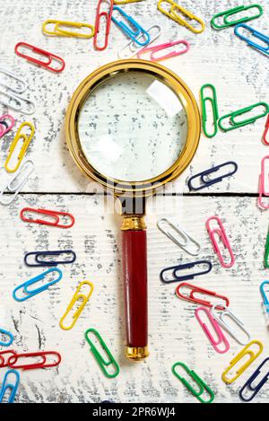 Magnifier With Important Message With Paperclips Around On Floor ...