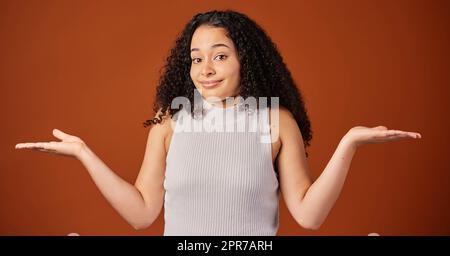 Portrait of young funny woman shrug shoulders dont know palms no idea ...