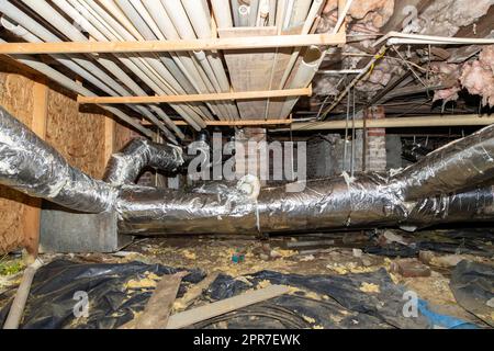Crawl Space under house with air conditioner duct work and insulation ...