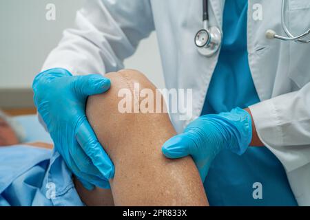 Surgical suture on the knee. Surgical wound sutured with special metal ...