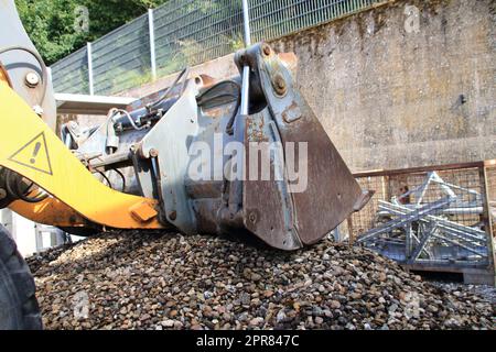 Shovel from a wheel loader was placed on a pile of gravel and ...