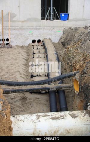 Empty conduits for cables lie in a trench Stock Photo - Alamy
