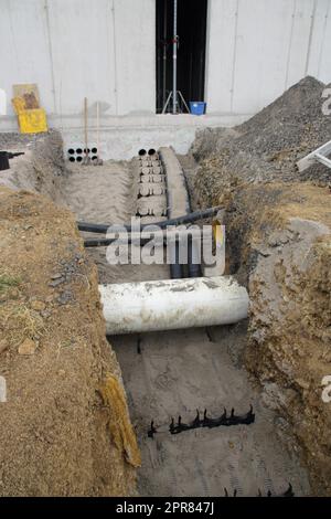 Empty conduits for cables lie in a trench Stock Photo - Alamy