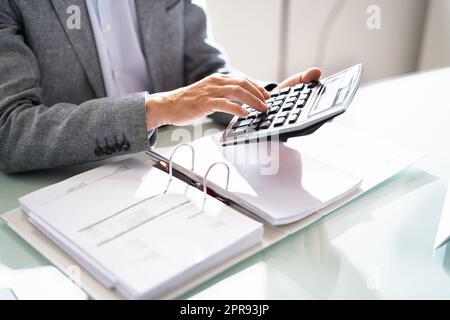 Lady Calculating Invoice. Chartered Accountant With Calculator Stock ...