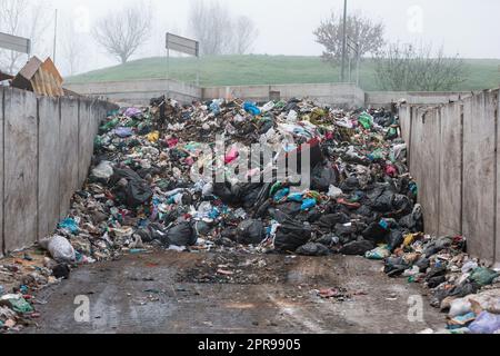 Landfill site, a pile of stinky different junk disposal in the concrete ...
