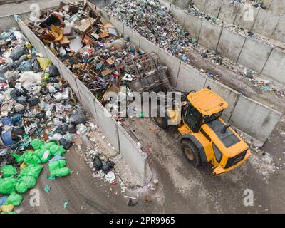 Handling construction waste on the landfill site, skid steer loader ...