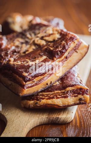 Whole smoked bacon on cutting board Stock Photo - Alamy