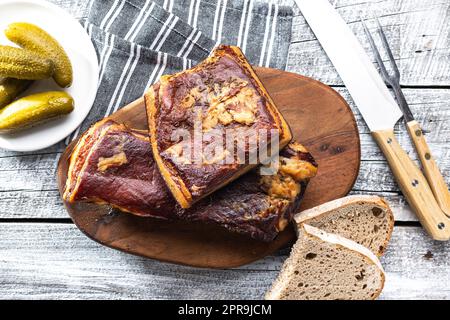 Whole smoked bacon on a cutting board. Top view Stock Photo - Alamy