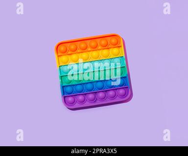 Popit toy on multicolor background, top view Stock Photo - Alamy