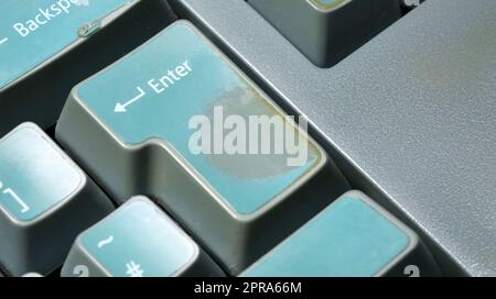 Simple worn faded enter key on an old computer desktop PC keyboard, top ...