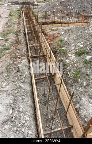 Reinforcement of a shallowly buried strip foundation of a low-rise ...