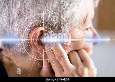 Hearing Aid And Painful Ear Ache. Hearing Issue Stock Photo - Alamy