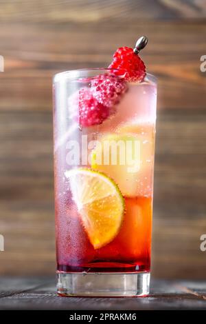 Sweet raspberry cocktail with lime slice. Selective focus. Shallow ...