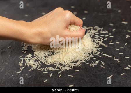 front view raw rice granules forming triangle shape on the dark ...