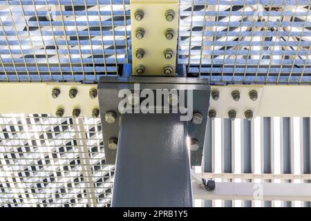 Part of a massive metal structure with bolts and rivets at the steel ...