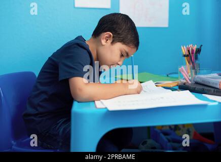 Im drawing this one for mom. an adorable little boy completing a school ...