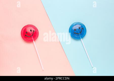 Red and blue lollipops with smiles on colorful background Stock Photo ...