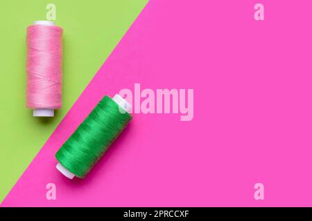 Two thread spools on color background Stock Photo - Alamy