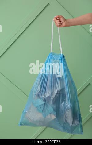 Female hand holding full garbage bag isolated on white background Stock ...