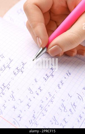 Math lesson. Notebook sheet in a cell with written mathematical ...