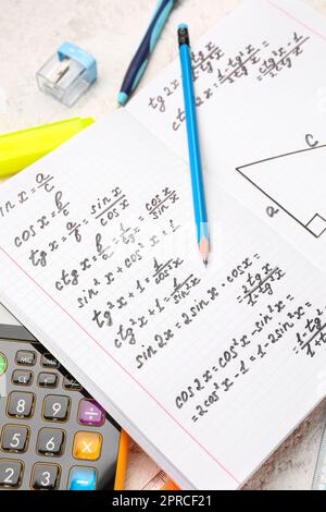 Copybook with maths formulas and pen, closeup Stock Photo - Alamy