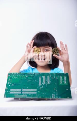 Little girl holding a bitcoin cryptocurrency coin in hands. A child ...