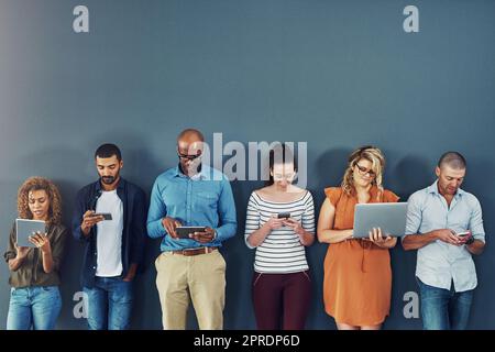 A group of people distracted due to the overuse of technology against ...