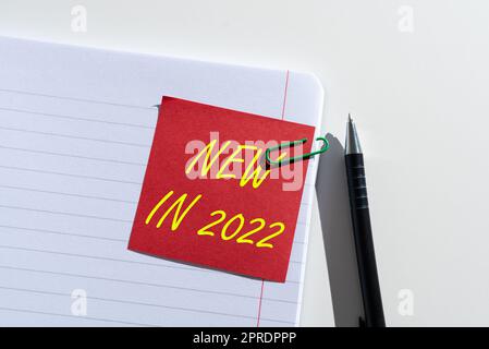2022 New Year with notebook, Christmas gift and pen on wood table. Xmas ...