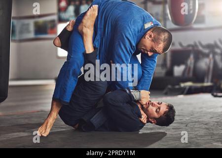Most fights end up on the ground. Full length shot of two professional ...