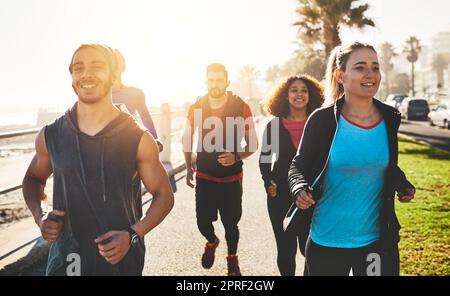 Miles fly when youre having fun. a fitness group out running on the ...