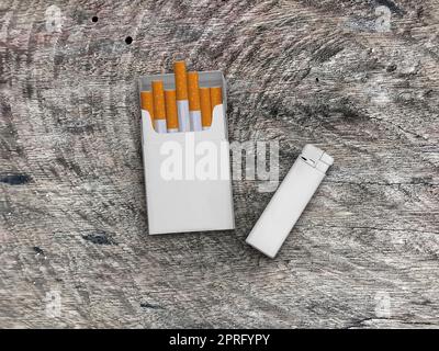 Cigarette pack and lighters on vintage wood texture background, top ...