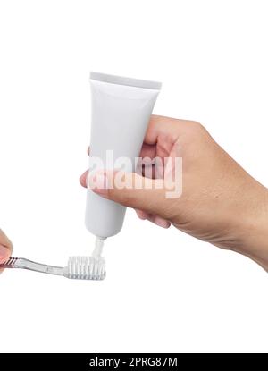 The guy squeezes toothpaste on the toothbrush Stock Photo - Alamy