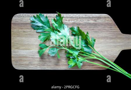 Bunch of parsley stem on a wooden cutting board Stock Photo - Alamy