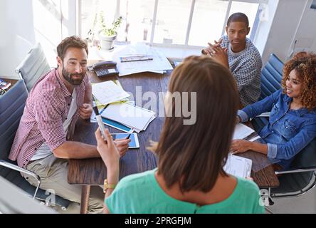 Addressing her team. a young businesswoman giving a presentation to her ...