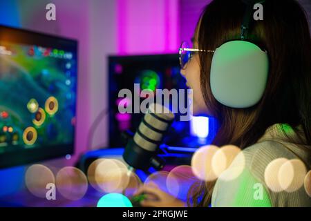 Asian young gamer woman playing video games online on computer she live ...