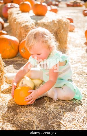 Adorable baby girl having fun with toys on colorful play mat. Happy ...