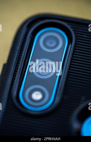 Taking photo with smartphone triple camera set isolated on white studio ...