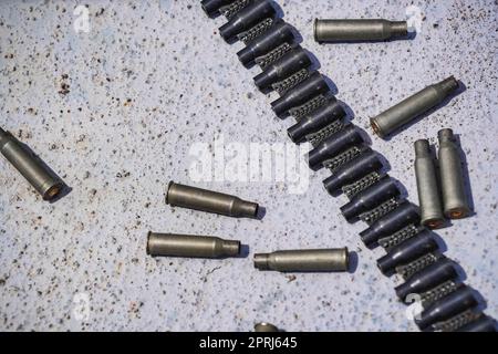 Machine gun empty bullet cartridges lay on the ground after being fired ...