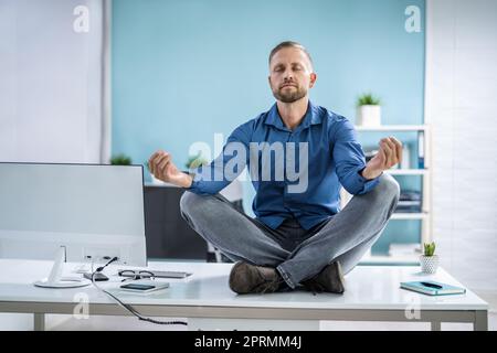 Employee Doing Mental Health Yoga Meditation In Office Stock Photo - Alamy