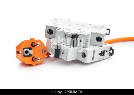 Circuit breaker and orange electric plug isolated on the white ...