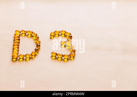 Bright oil yellow pills forming shape D3. Vitamin D3 capsules. Medicine ...