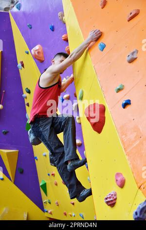 Man Climbing Up On Practice Wall Indoor Stock Photo - Alamy