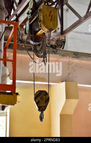 Industrial crane hook in a building interior Stock Photo - Alamy