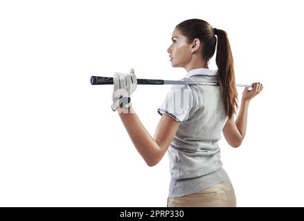 Confident golf player with club behind back smiling on camera at course ...