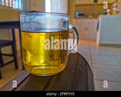 Glass or cup pot with hot ginger tea on a wooden table in Mexico Stock ...
