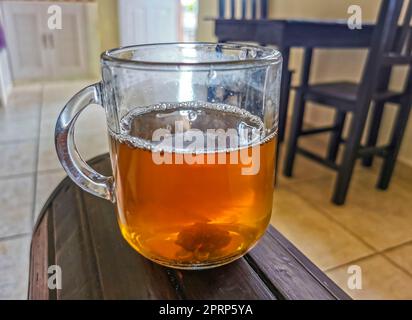 Glass or cup pot with hot ginger tea on a wooden table in Mexico Stock ...